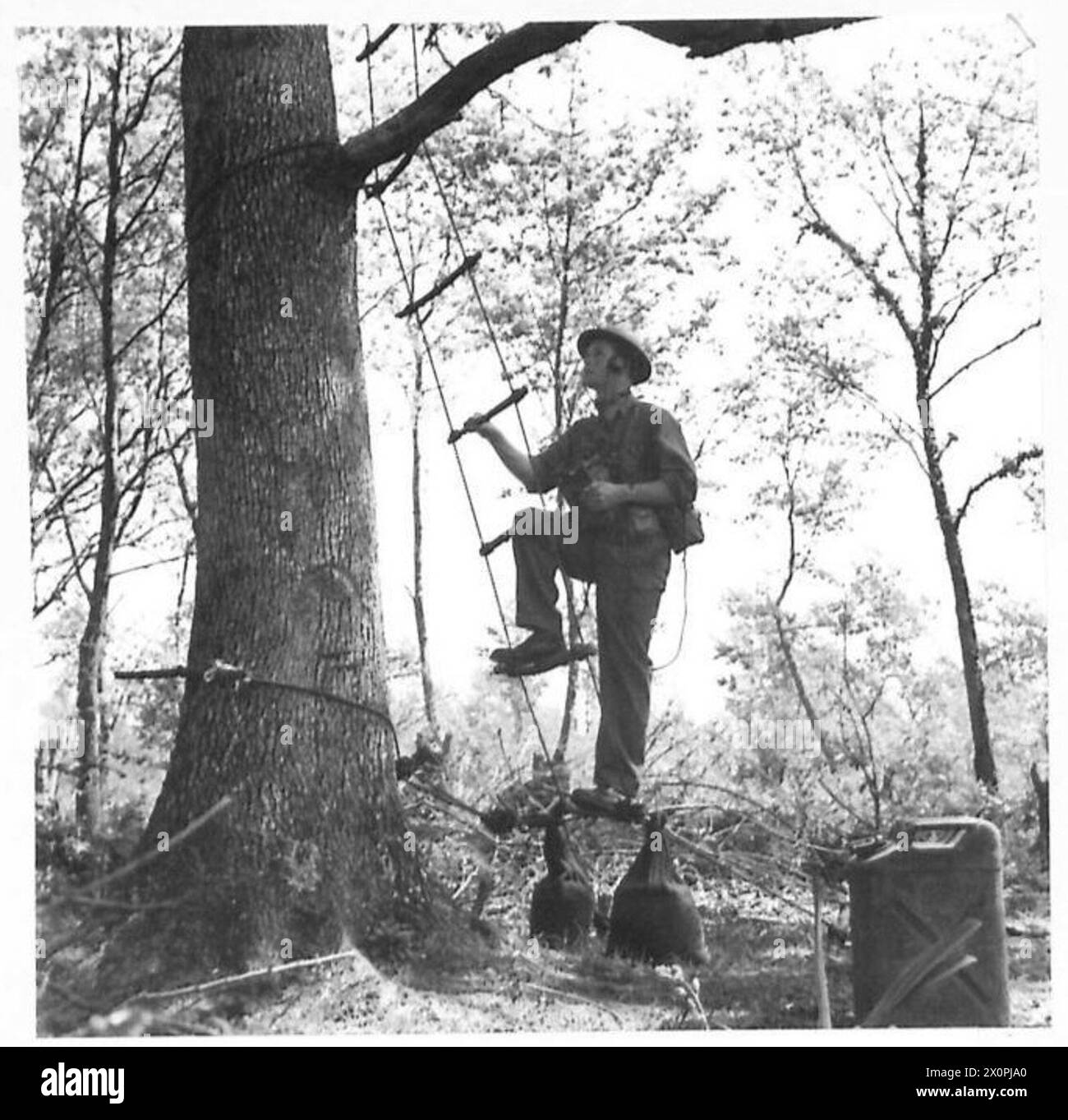 Photograph shows Lieutenant Taylor climbing to a 35-feet high ...