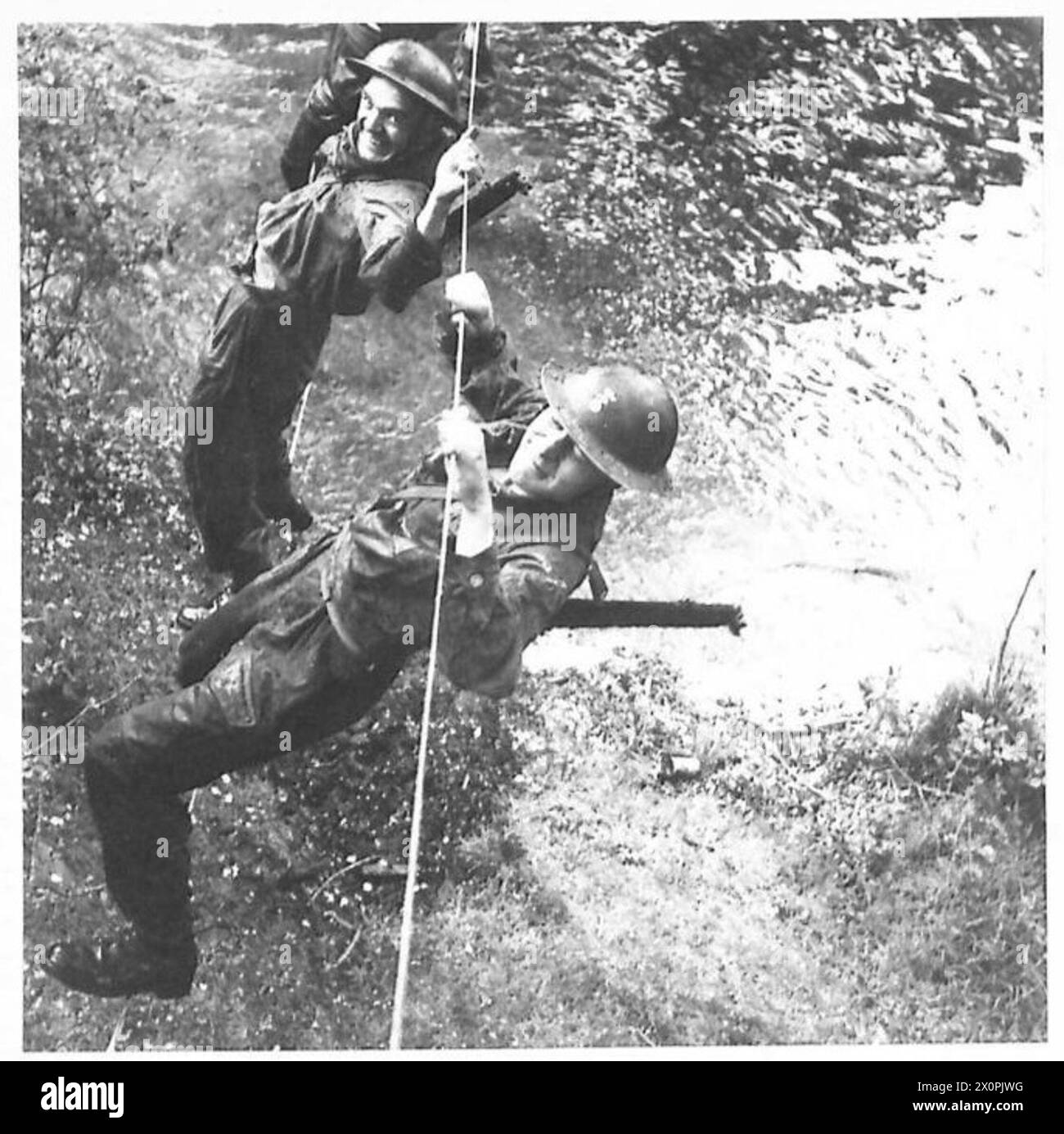 Soldiers cross streams using suspended wire bridges as part of physical ...