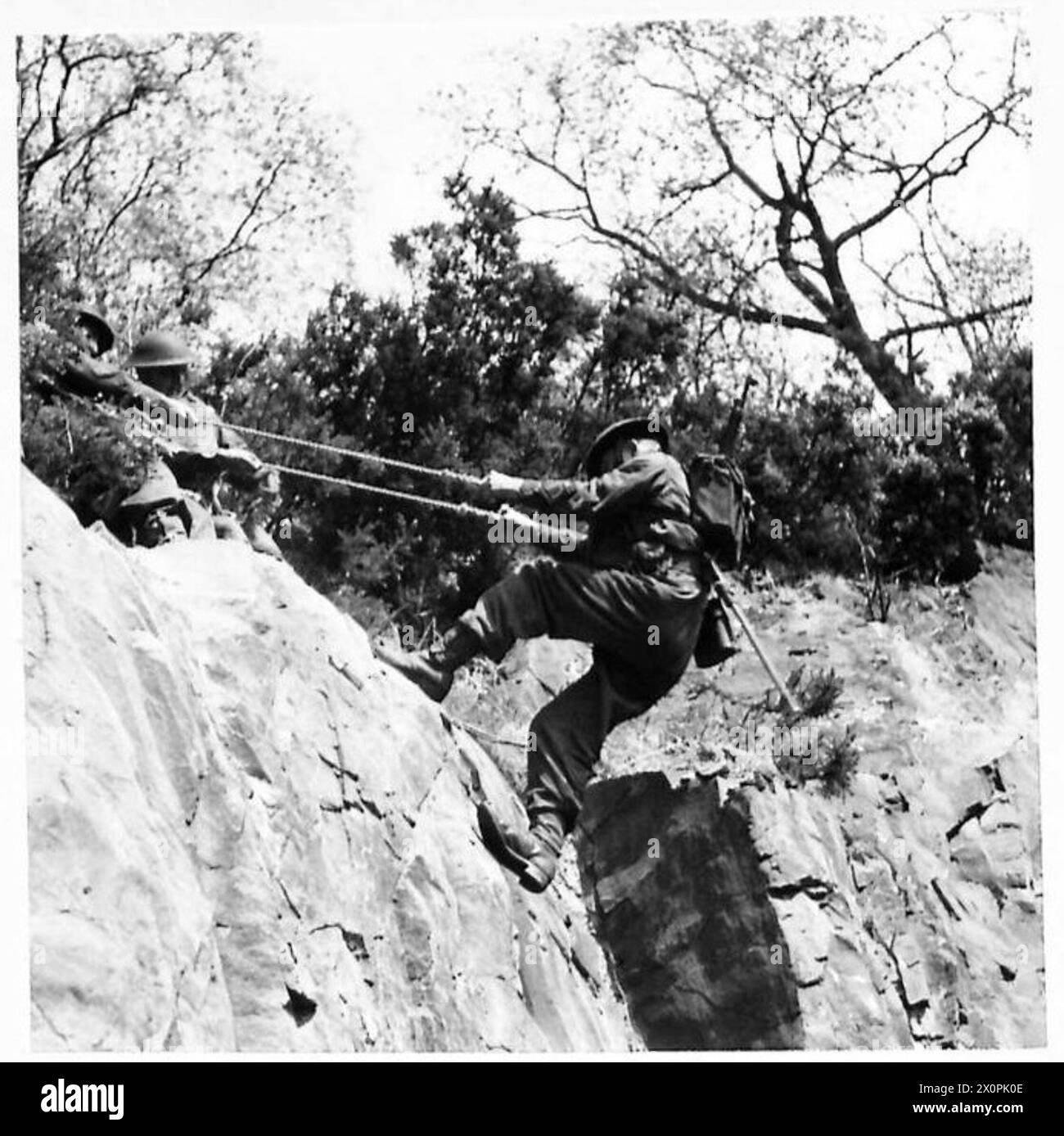 ROCK CLIMBING - Aided by ropes these lads have to scale a cliff face ...