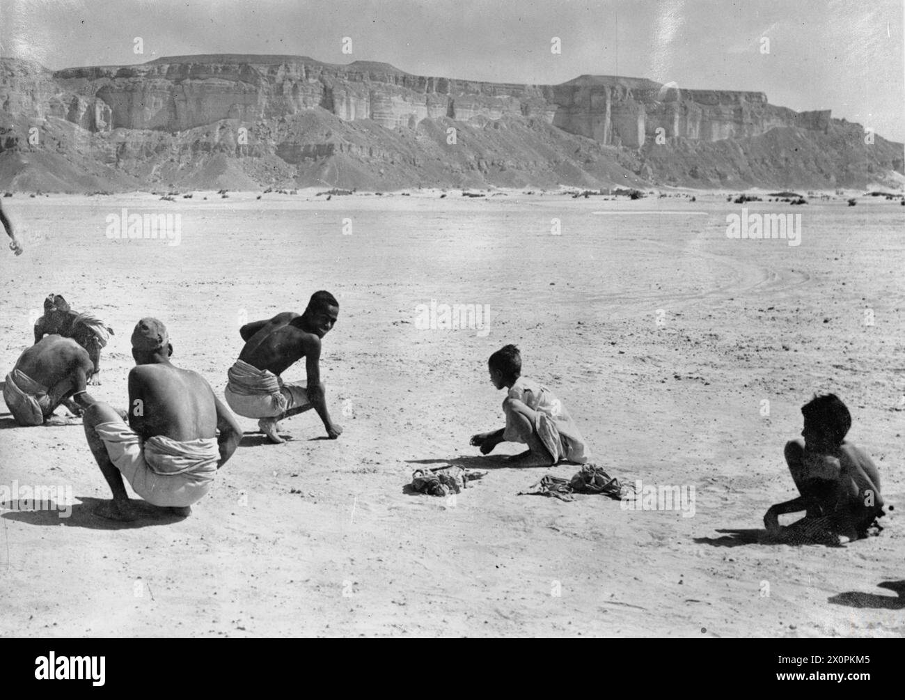 Hadrami civilians collect grain dropped by RAF Famine Relief Flight ...