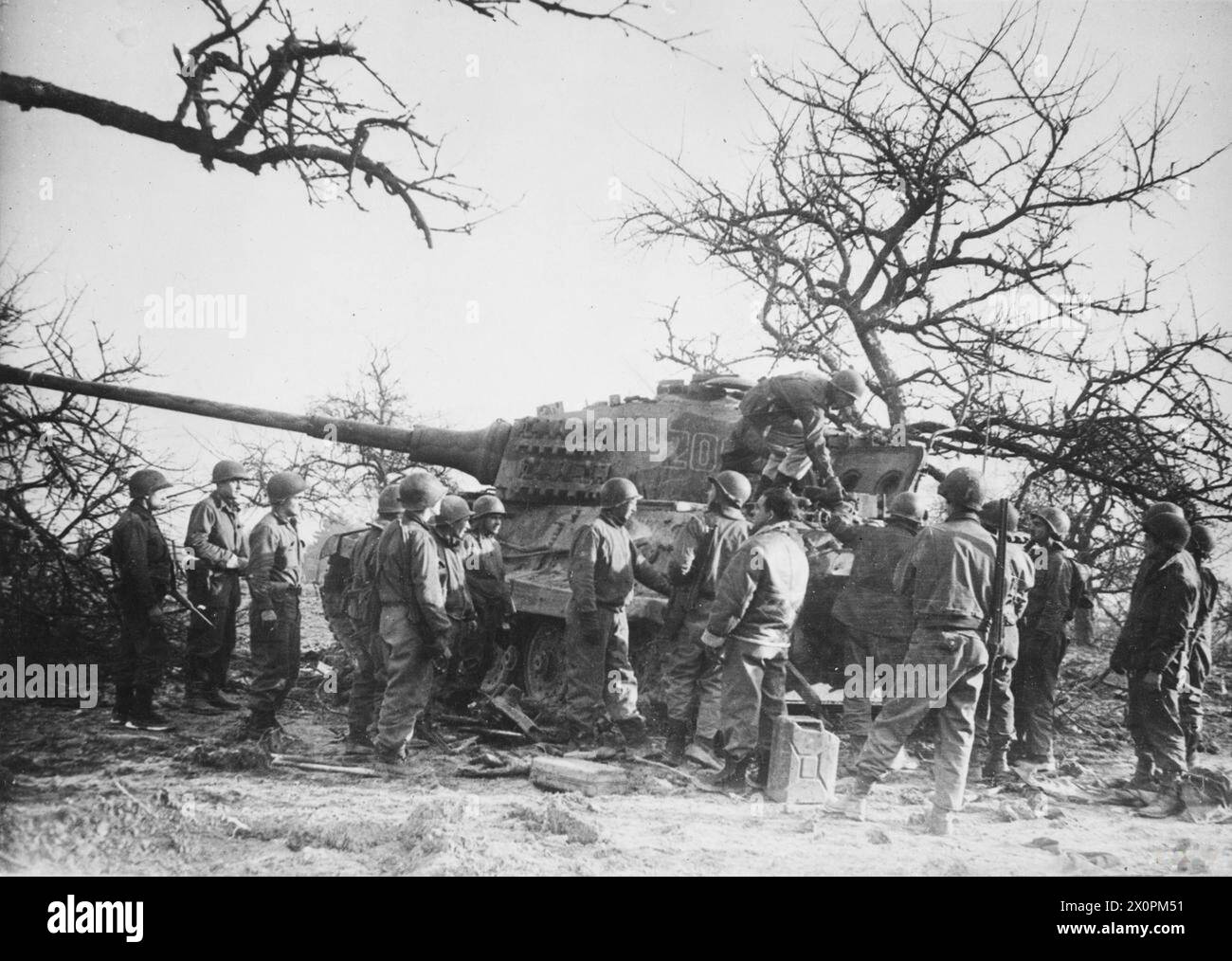 US troops inspect a disabled German Tiger II tank and other military ...