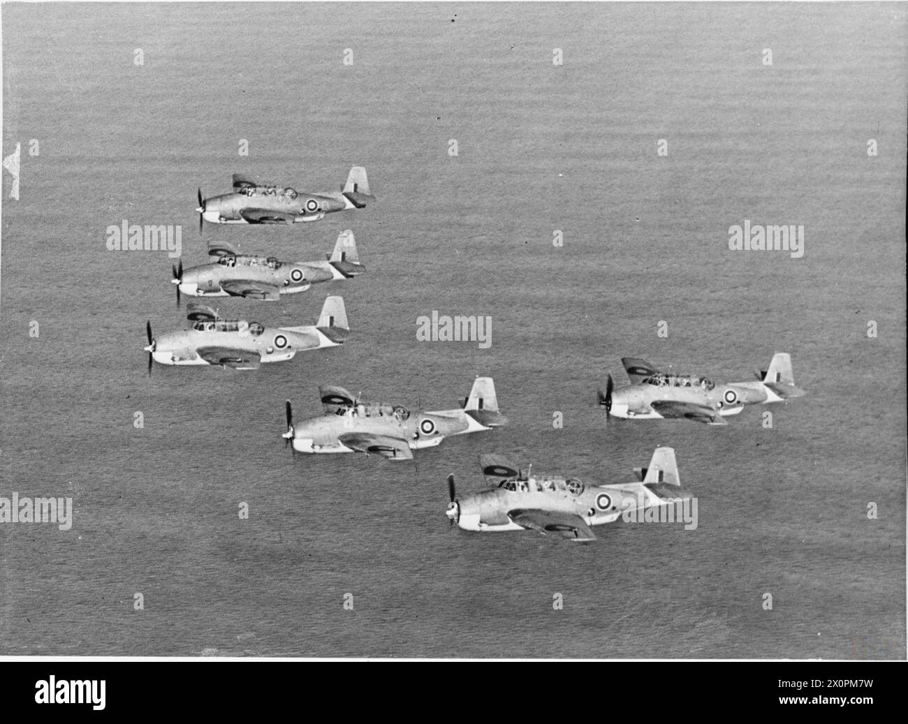 Six American-built Grumman Avenger torpedo bombers fly in box formation ...
