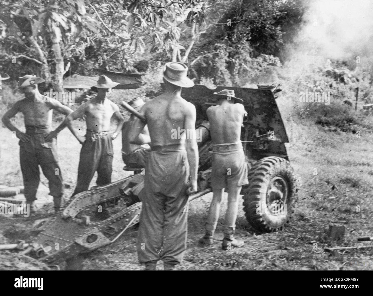 THE BRITISH ARMY IN BURMA 1944 - Men of the 36th Infantry Division firing a 25-pdr field gun ...