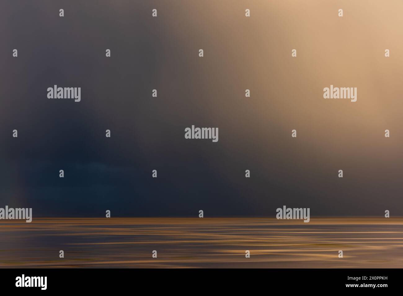 Stunning dramatic stormy skies over ocean landscape with distant heavy ...