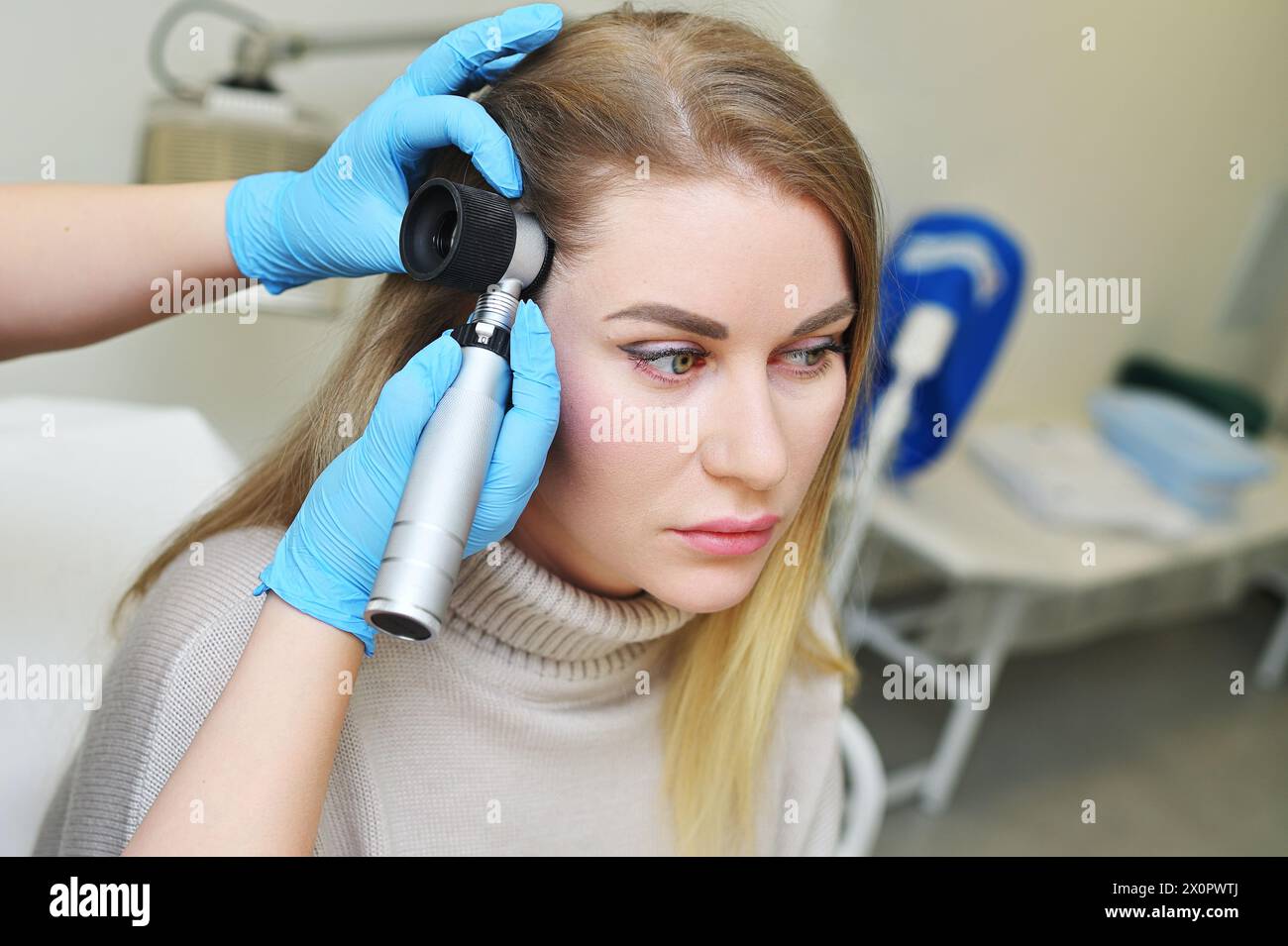 dermatologist holds a dermatoscope in his hands and examines the ...