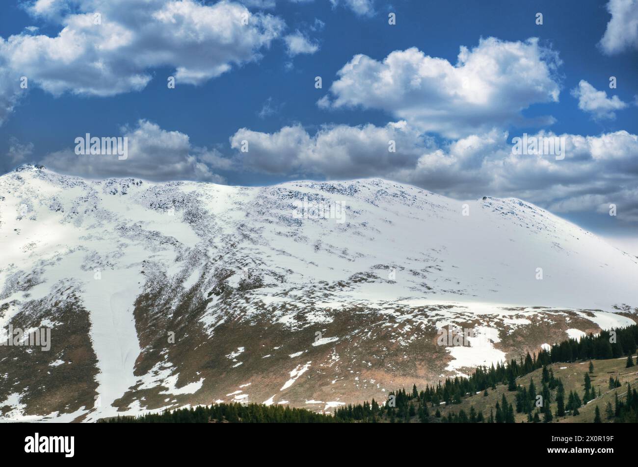 This stunning landscape showcases a snow-capped mountain in the ...