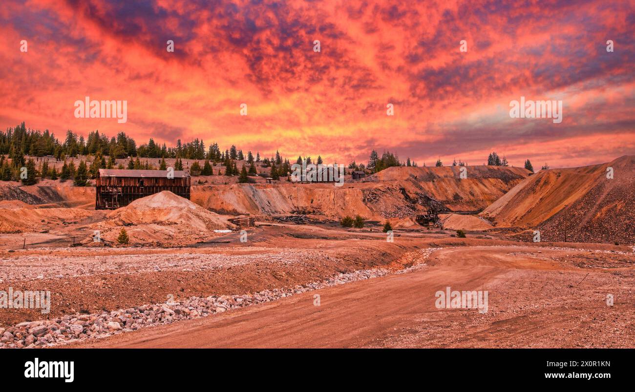 The fiery hues of sunset bathe a Colorado mining site in warm light ...