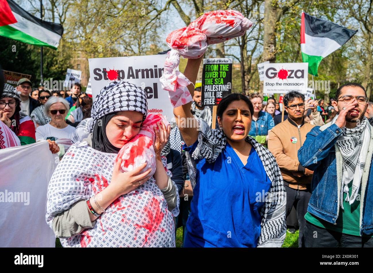 London, UK. 13th Apr, 2024. Carrying 'blood stained' bundles to ...