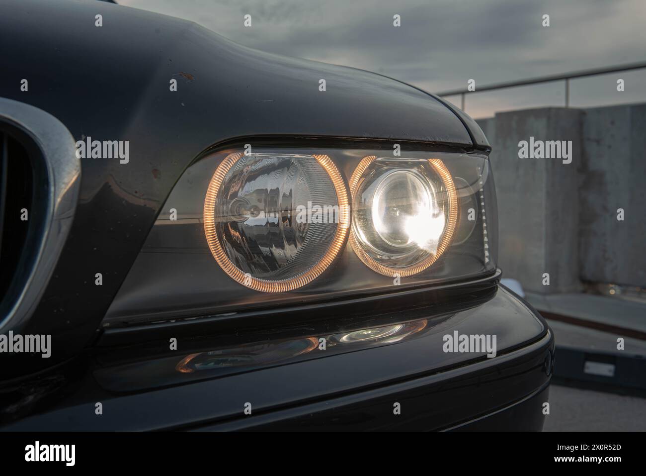 The xenon lights of the BMW E39 525D Touring car shine Stock Photo - Alamy