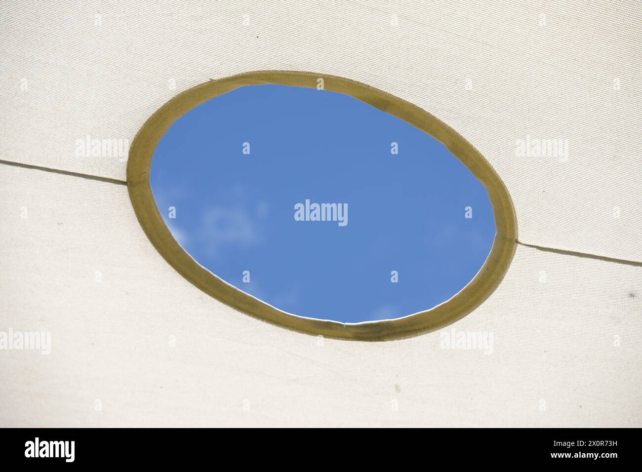Abstract white interior fragment. Blue cloudy sky behind the round ...
