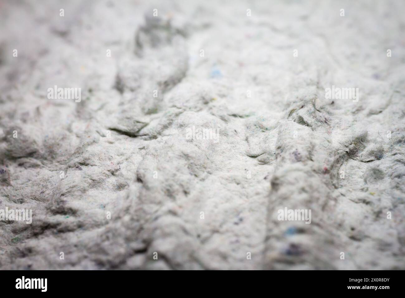 Extreme close up of old gray handmade paper mache with a structure and ...