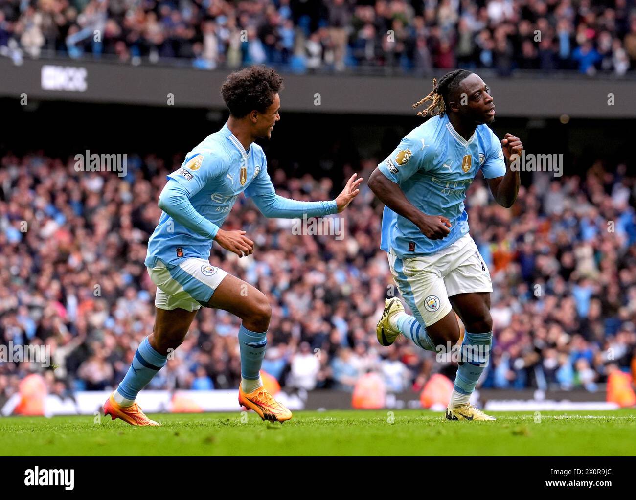Manchester City's Jeremy Doku (right) celebrates scoring their side's ...