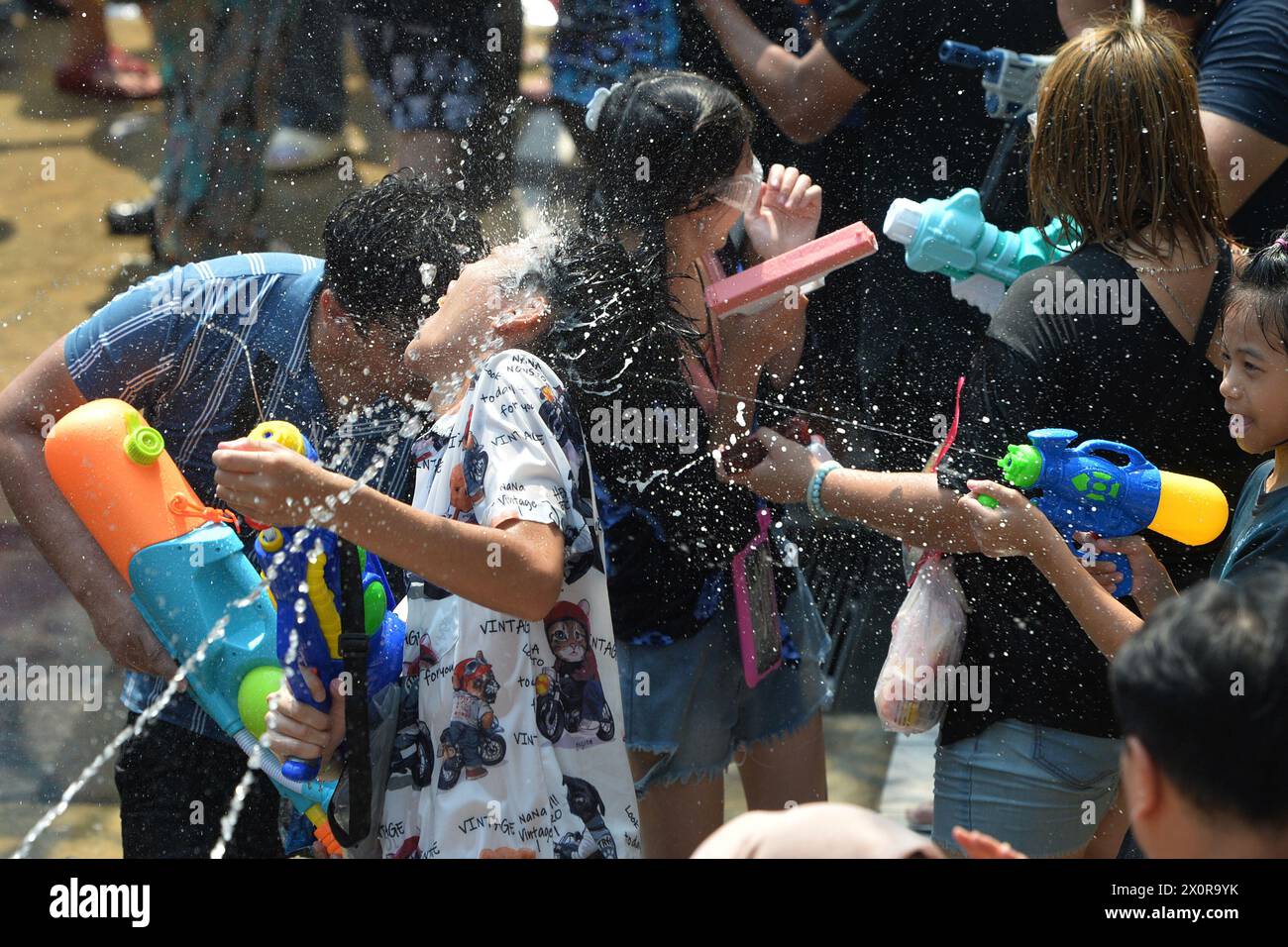 Bangkok, Thailand. 13th Apr, 2024. People splash water on one another ...