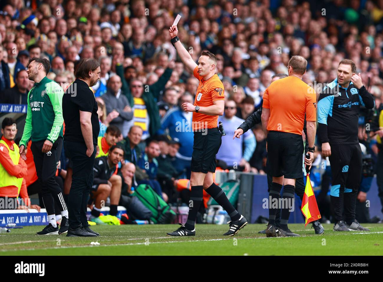 Leeds, UK. 13th Apr, 2024. Referee James Bell shoes a red card to Leeds ...