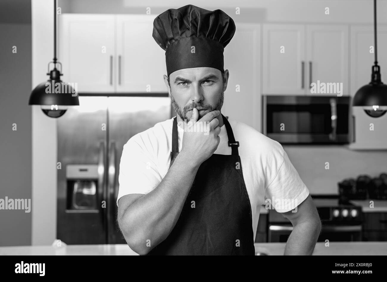 Chef on kitchen. Professional chef man in uniform on kitchen. Bearded ...