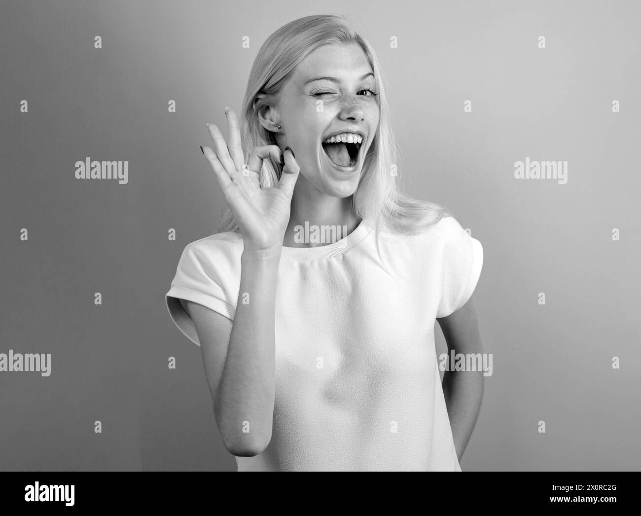 Close up portrait of a pretty young woman winking. Cute funny lady ...