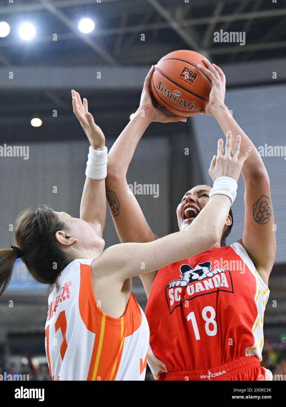 Hohhot, China's Inner Mongolia Autonomous Region. 13th Apr, 2024. Elizabeth Cambage (R) of ...