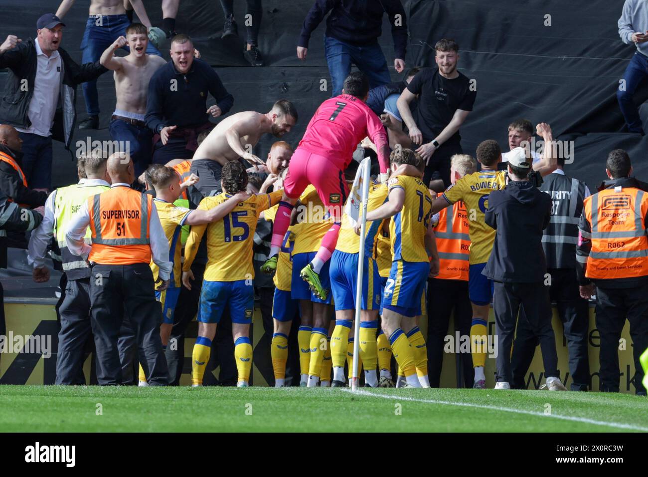 James Gale celebrates with team mates after scoring for Mansfield Town ...