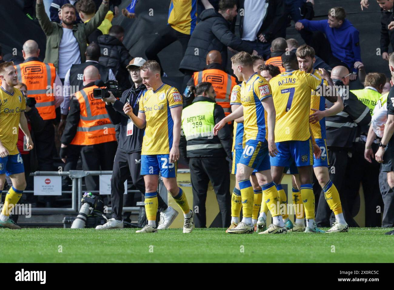 James Gale celebrates with team mates after scoring for Mansfield Town ...