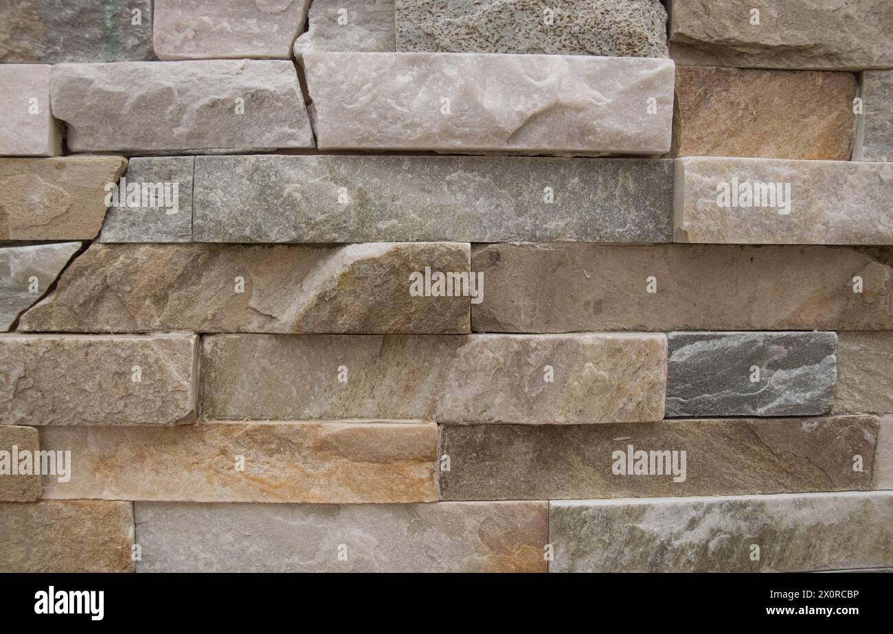 Beautiful beige structural stone wall of the ancient building consists ...