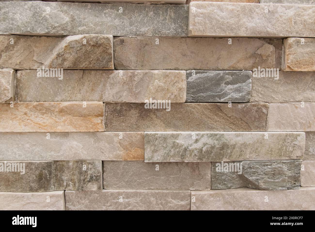 Beautiful beige structural stone wall of the ancient building consists ...