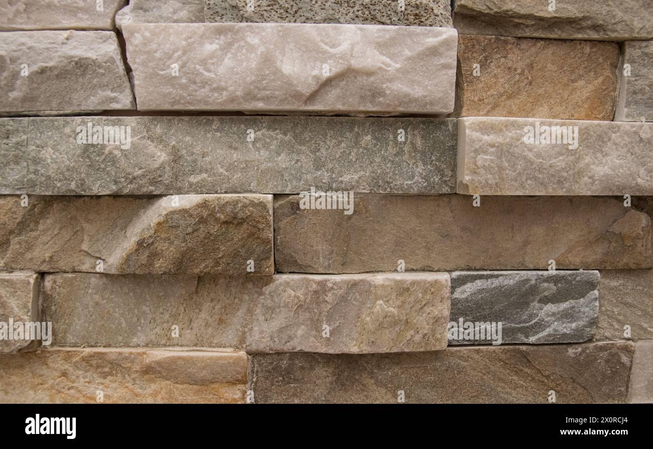 Beautiful beige structural stone wall of the ancient building consists ...