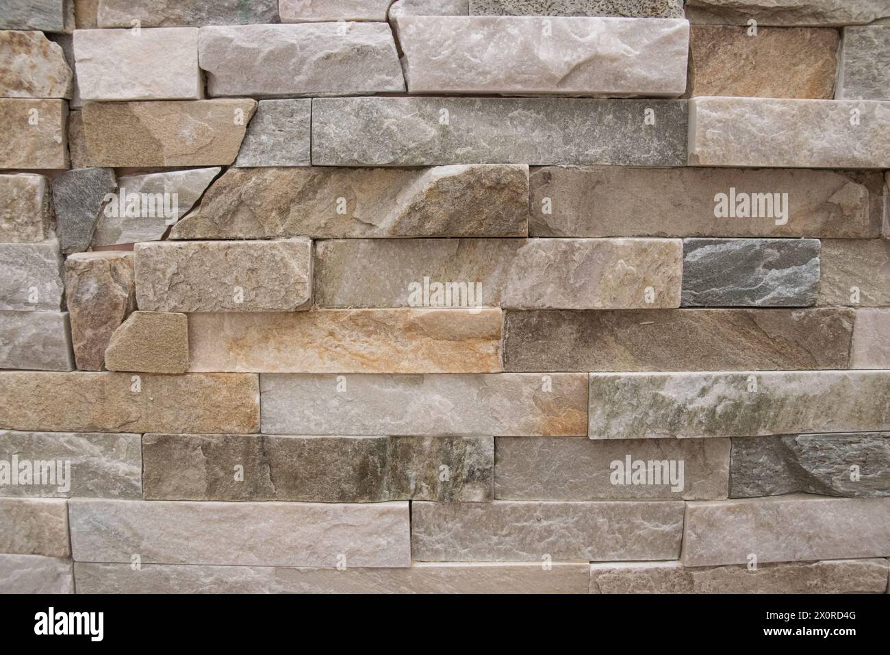 Beautiful beige structural stone wall of the ancient building consists ...