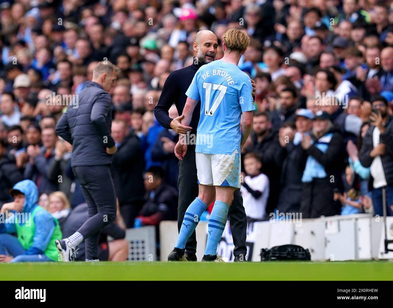 Manchester City's Kevin De Bruyne speaks to manager Pep Guardiola after ...