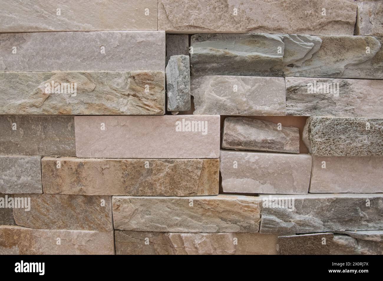 Beautiful beige structural stone wall of the ancient building consists ...