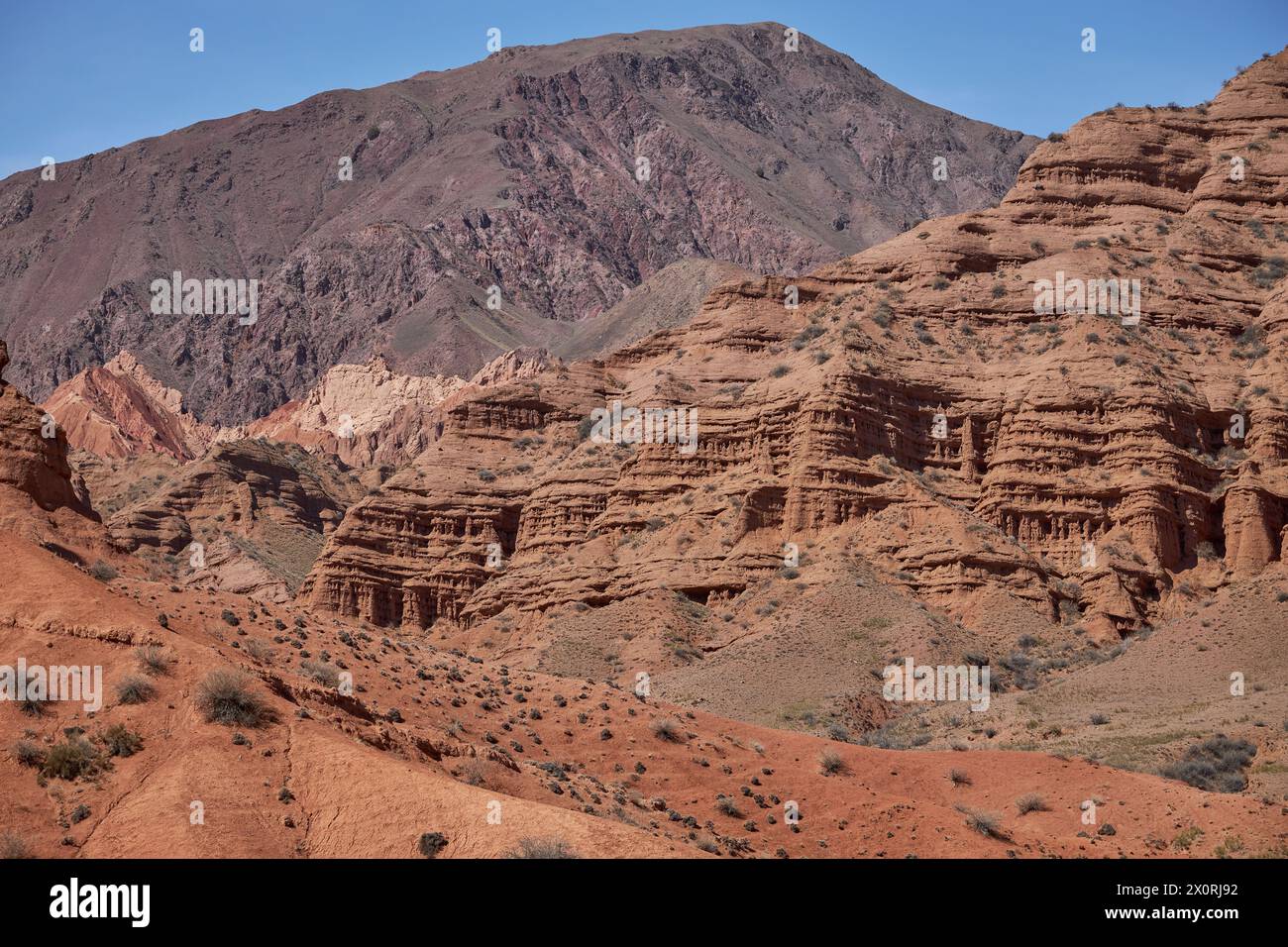 Kyrgyzstan nature, Konorchek Canyon valley. Red sandstone rocks, cliffs ...