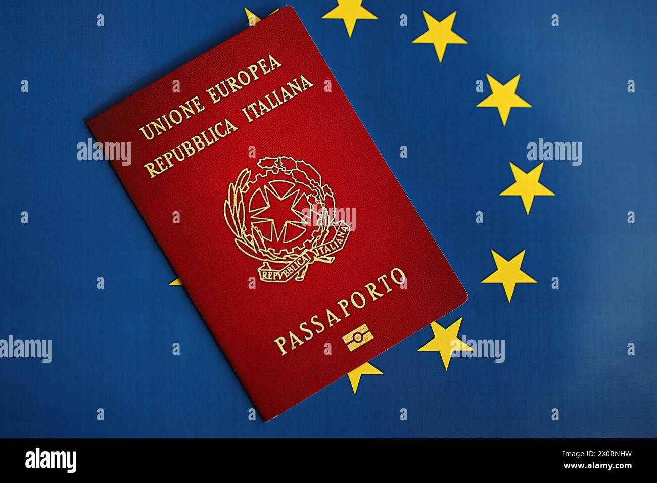 Italian passport of European Union on blue flag background close up ...