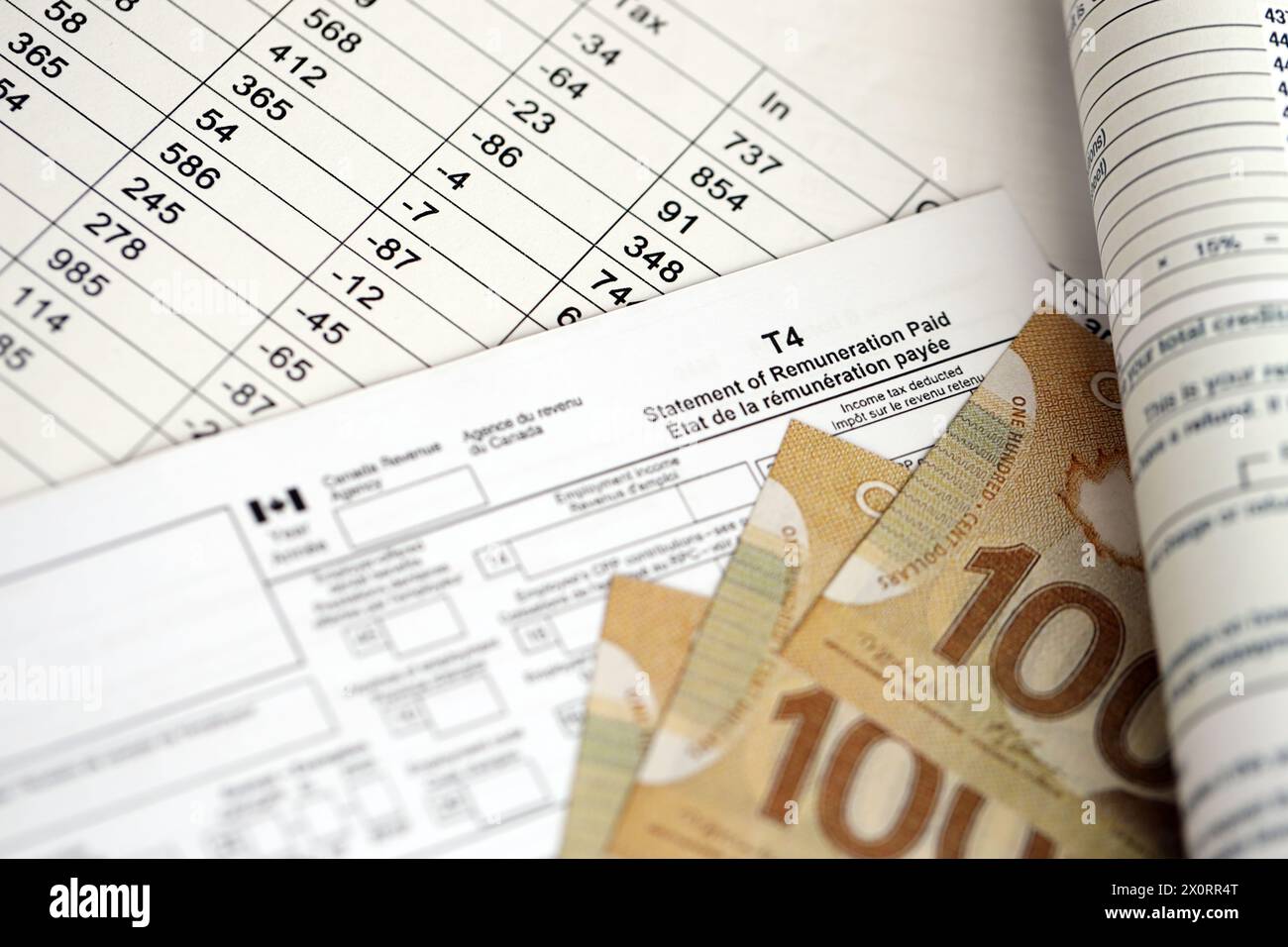 Canadian T4 tax form Statement of remuneration paid lies on table with ...
