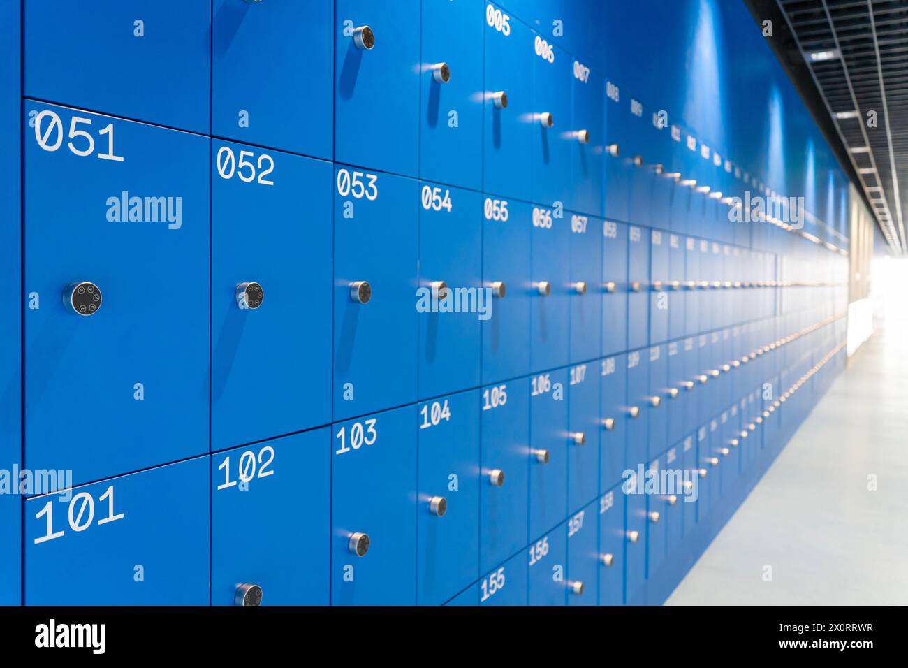 Row of blue lockers with number locks Stock Photo - Alamy