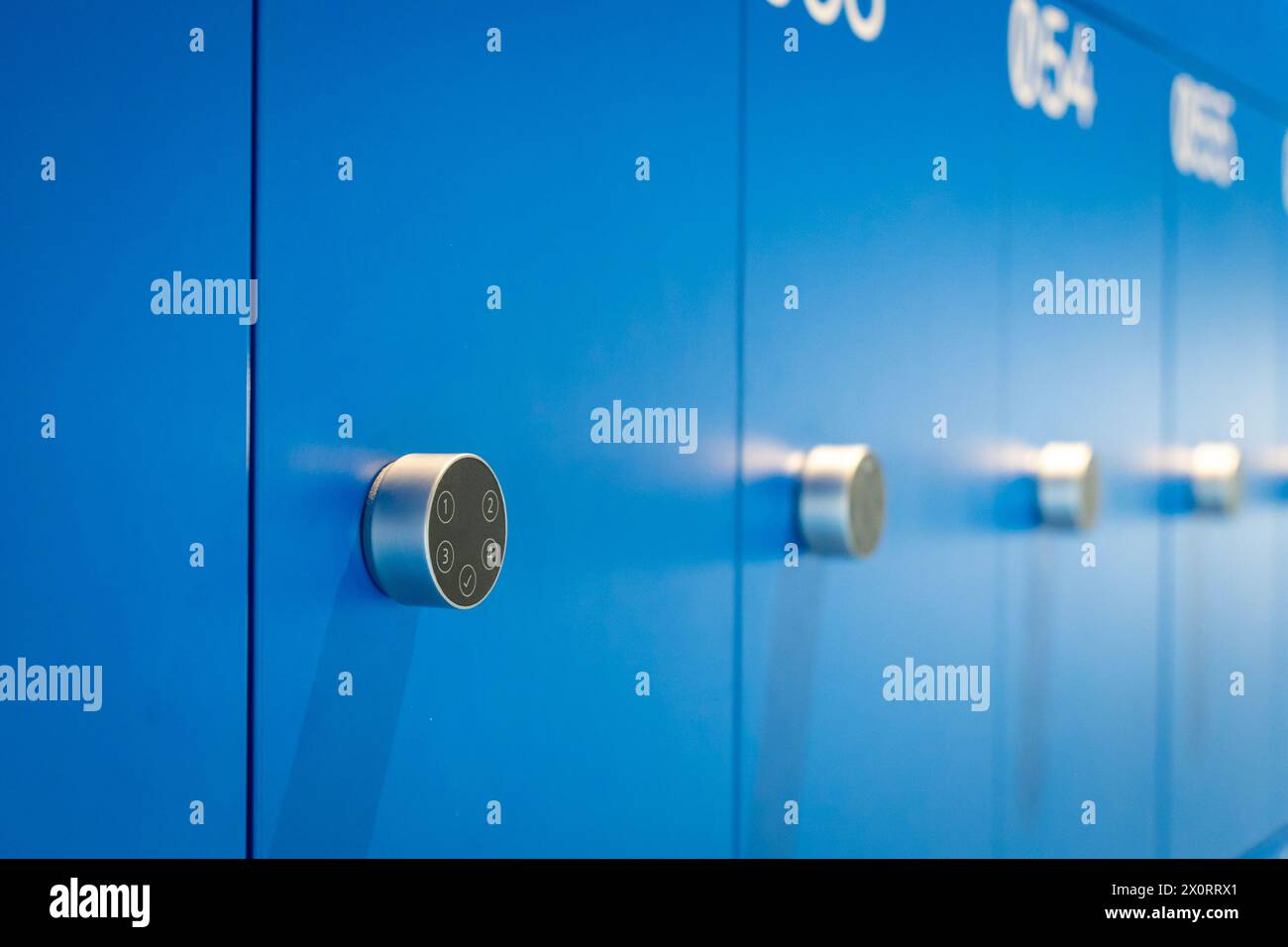 Row of blue lockers with number locks Stock Photo - Alamy