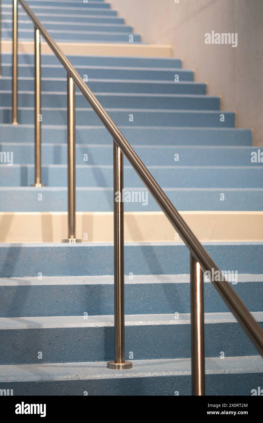 Light blue staircase with gray metal railing in a building Stock Photo ...