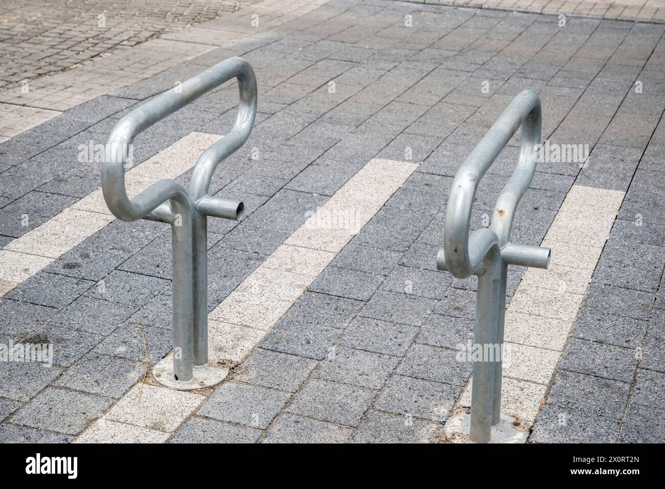 Bicycle rack bollards closeup in city street Stock Photo - Alamy