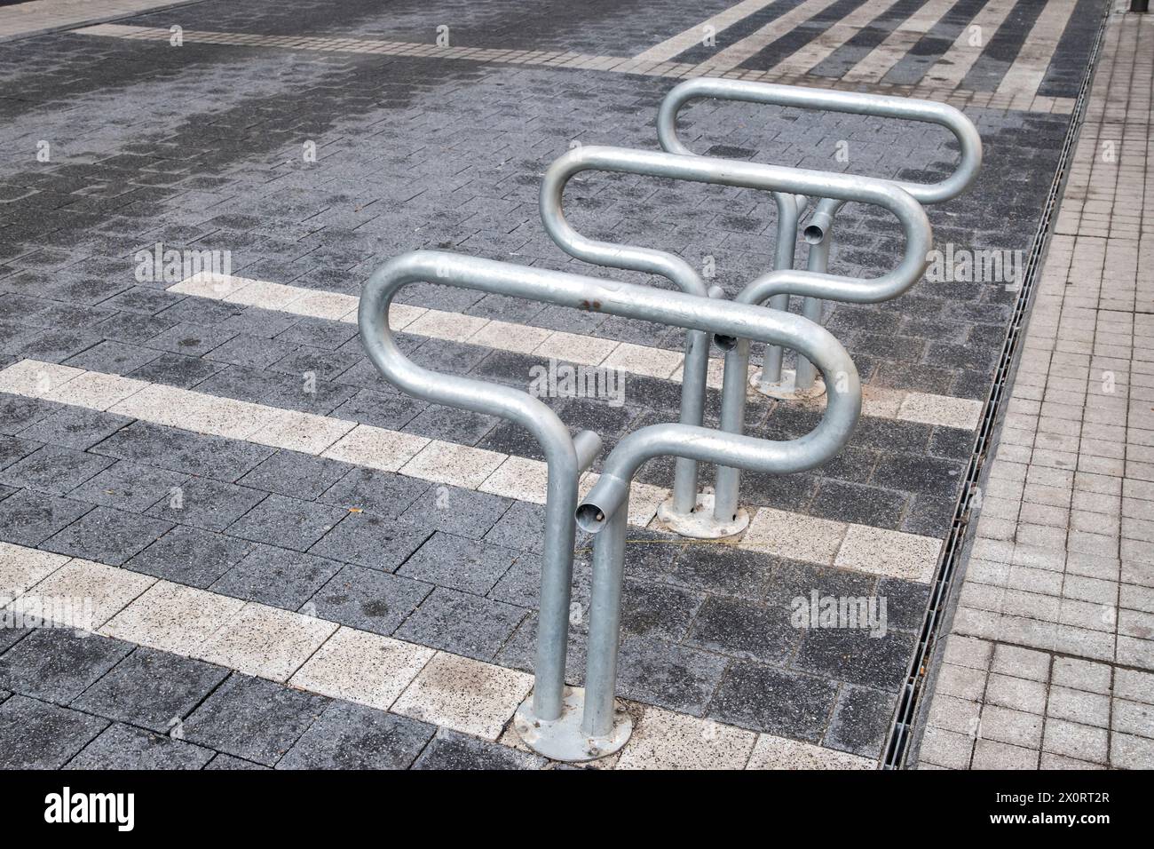 Bicycle rack bollards closeup in city street Stock Photo - Alamy
