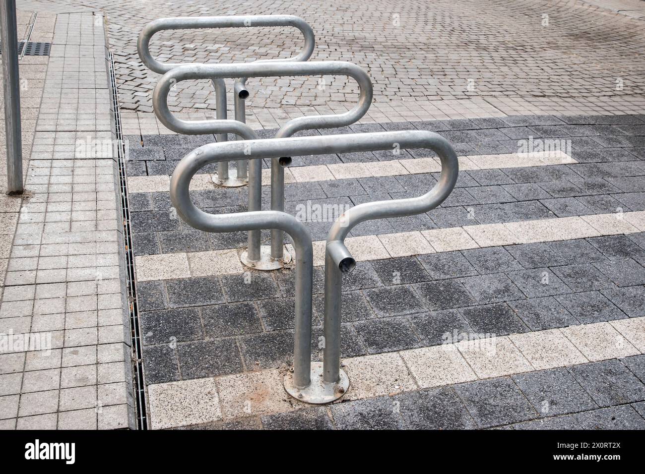 Bicycle rack bollards closeup in city street Stock Photo - Alamy