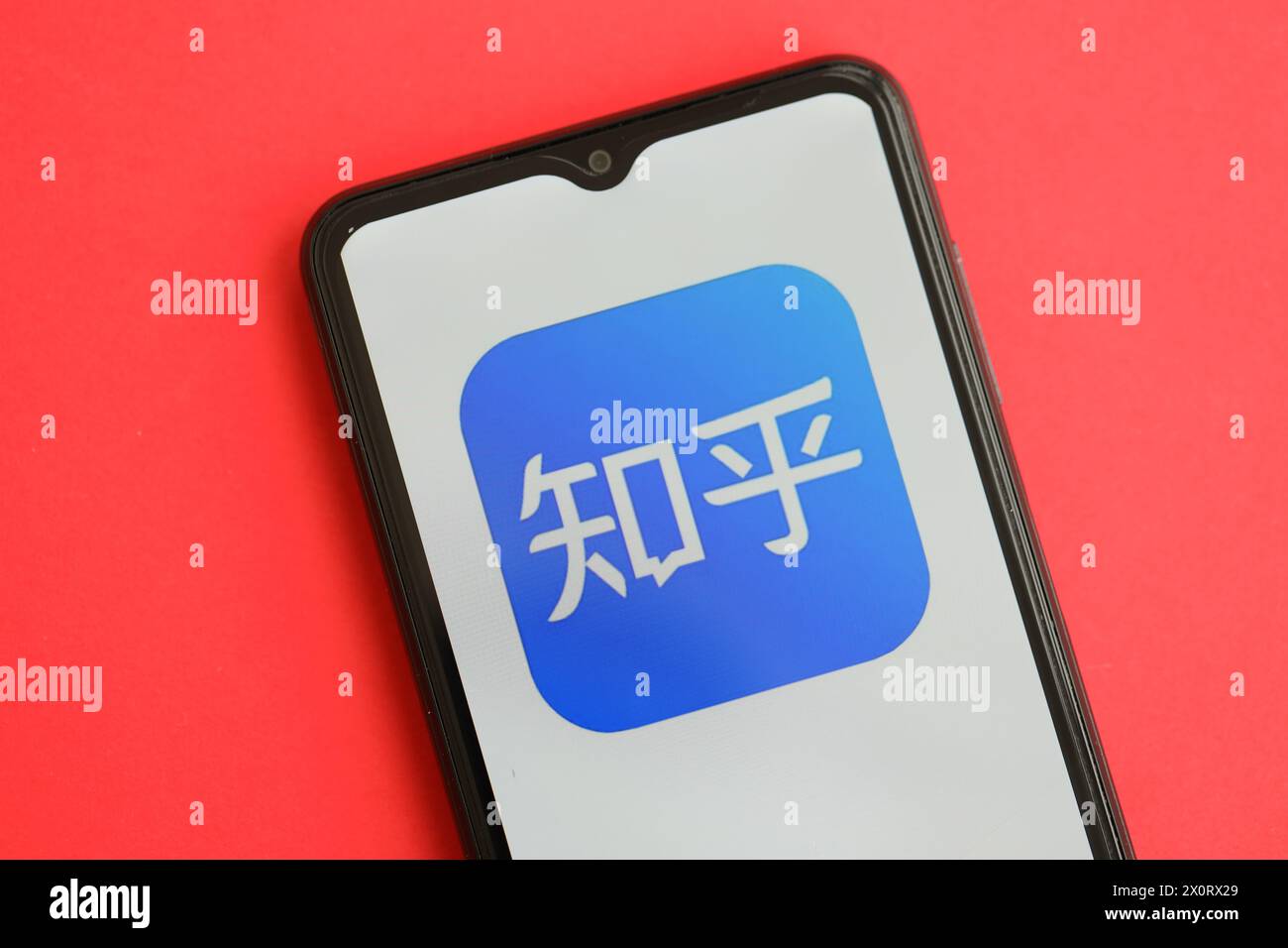 KYIV, UKRAINE - APRIL 1, 2024 Zhihu icon on smartphone screen on red ...