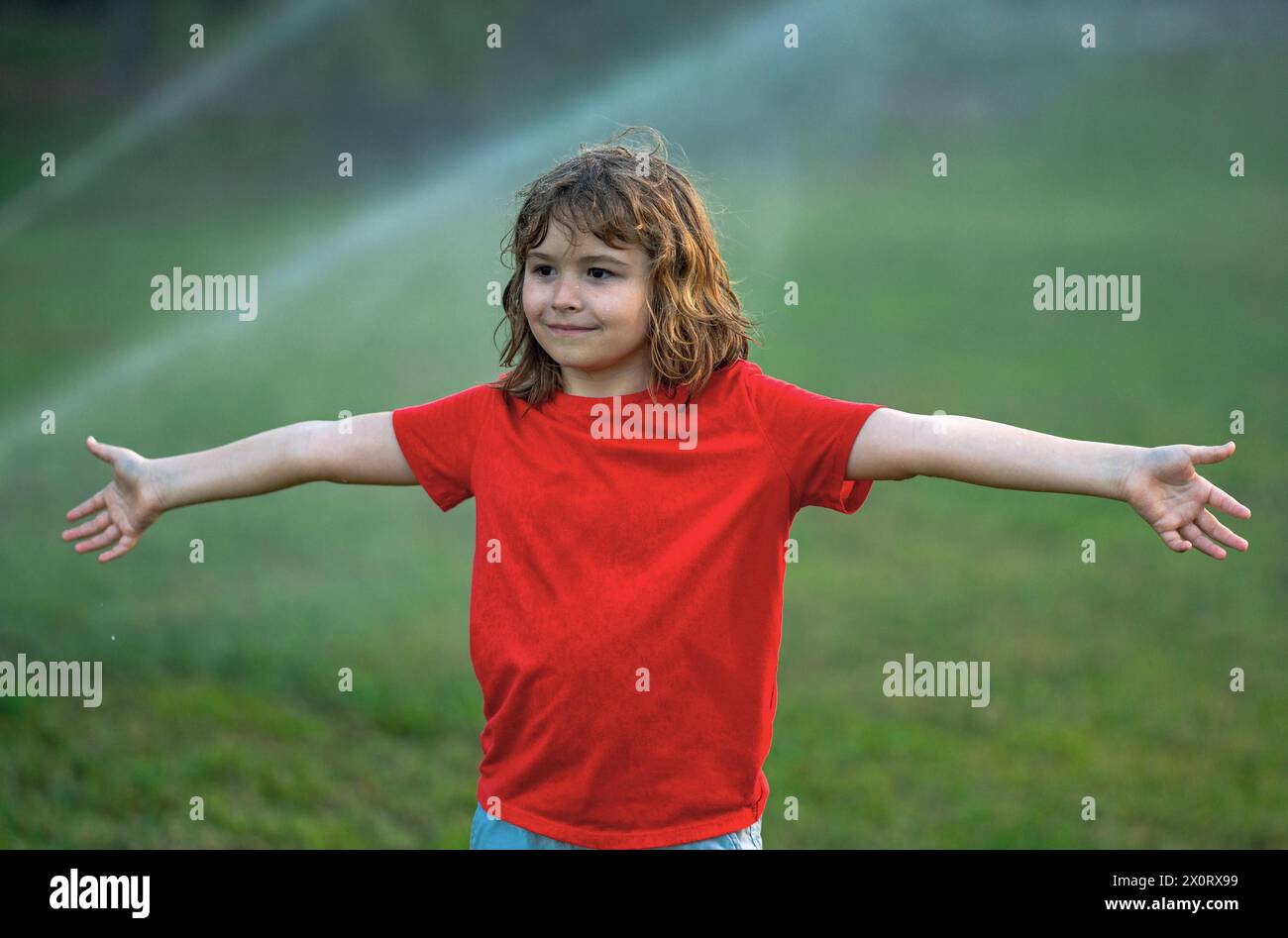 Wet child face. Cute little kid play in garden at summer day. Child ...