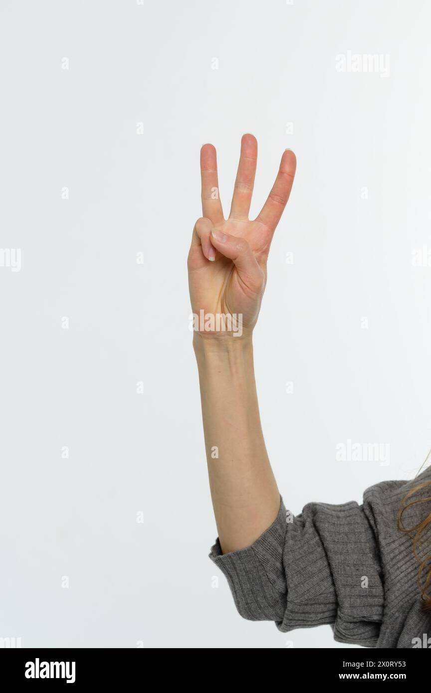 Pointing up with fingers number three. Close up, isolated on white ...