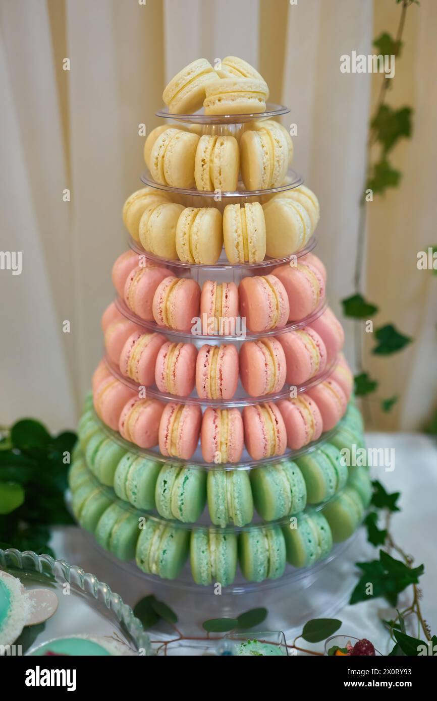 Macaron tower or pyramid and cupcakes on sweet dessert table Stock ...