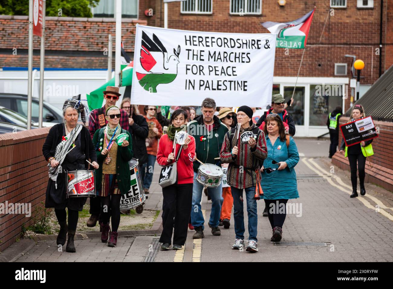 Hereford, UK. 13th Apr, 2024. Protestors march past Tesco supermarket ...