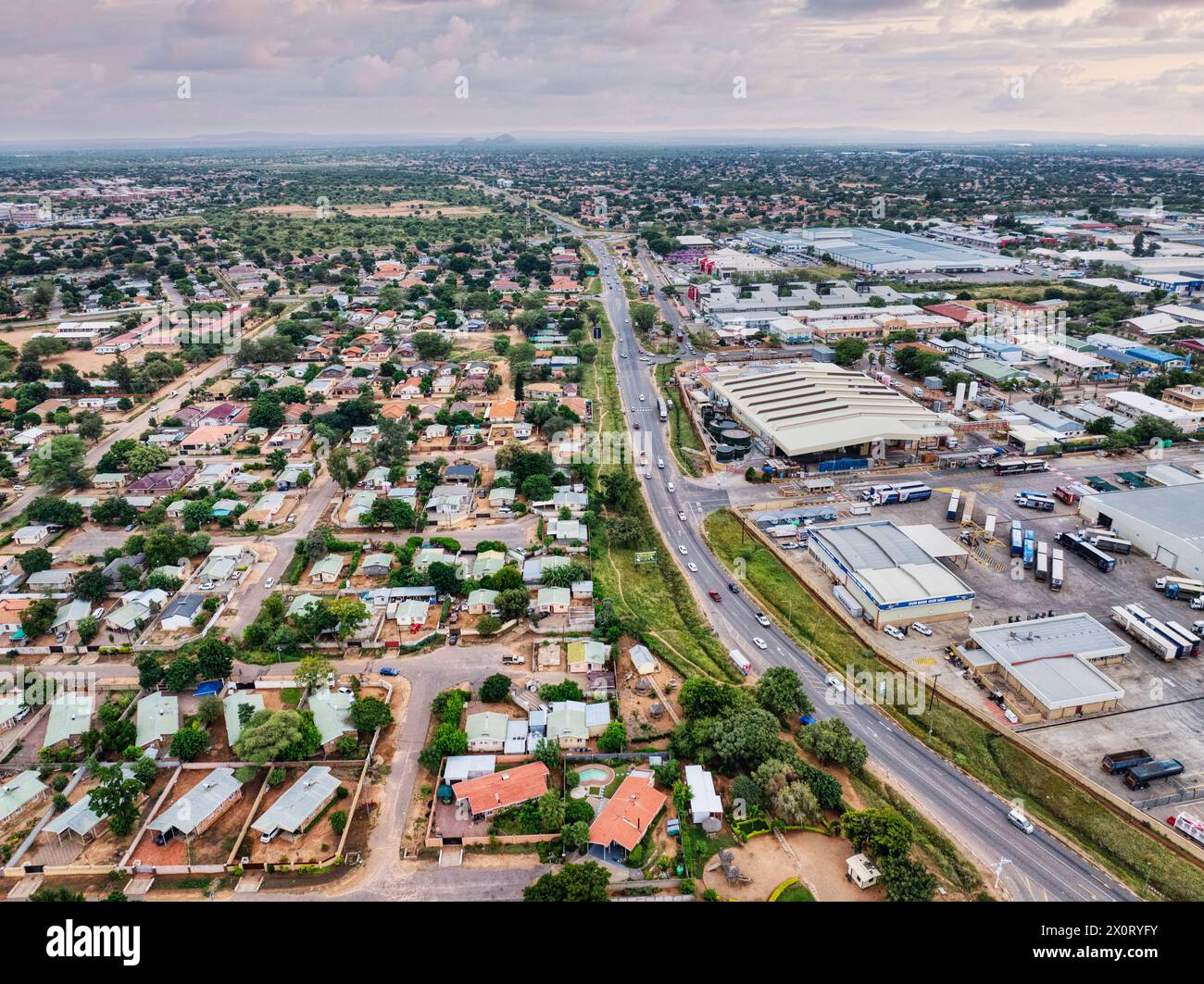 aerial view of residential and industrial area split by a road in ...