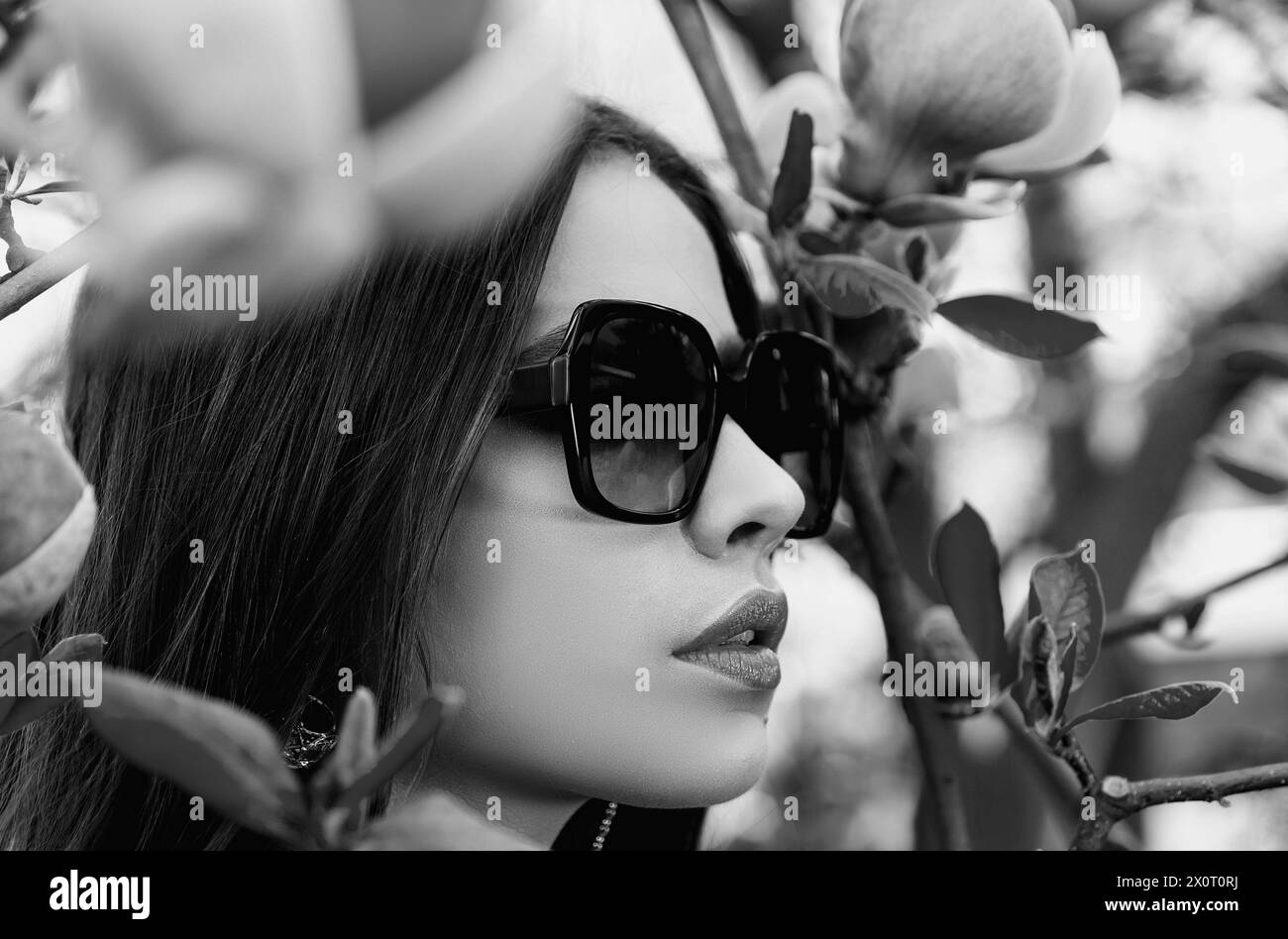 Young woman near blossom park. Spring girl. Woman on spring blooming ...