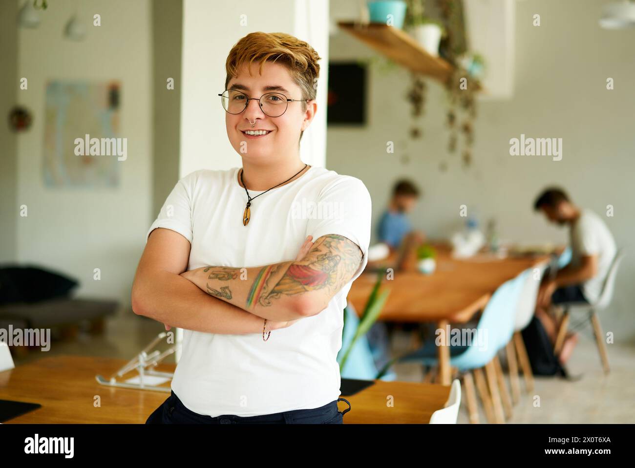 Transgender male professional smiles confidently, standing in open ...