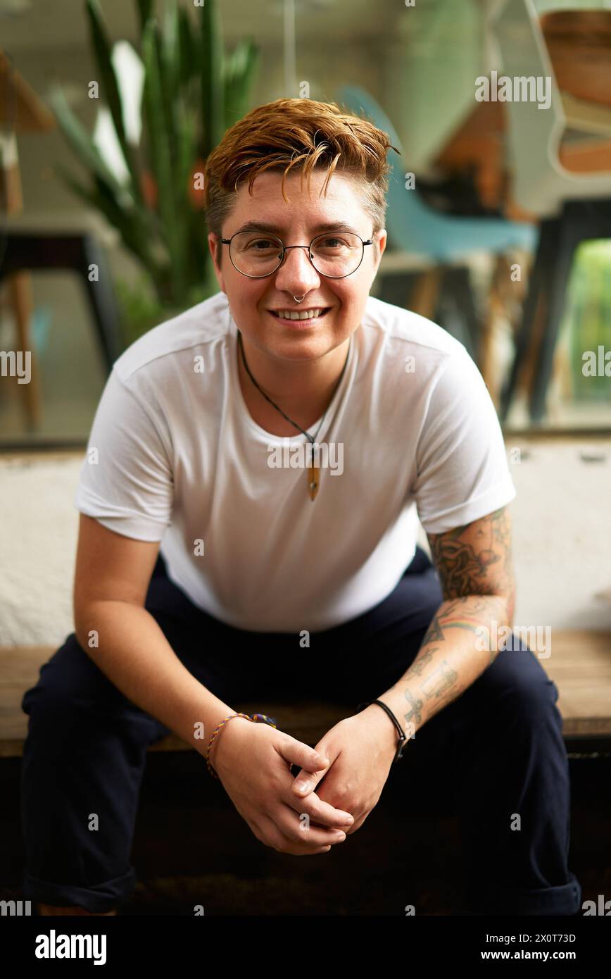 Confident transgender man in casual clothes smiles at camera, modern ...