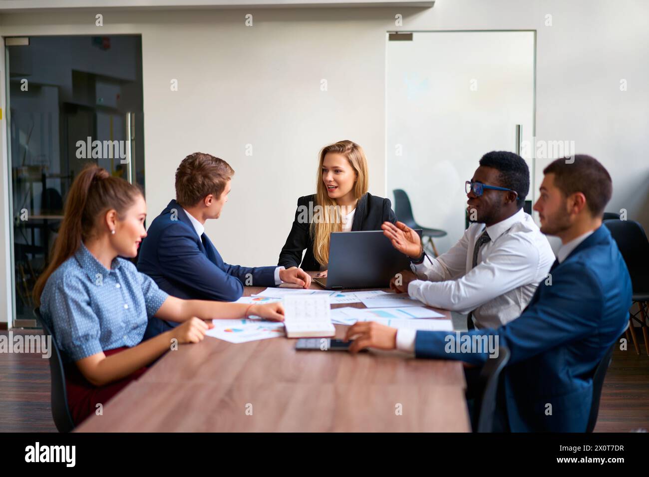 Female CEO leads boardroom meeting with multiracial execs, discussing ...
