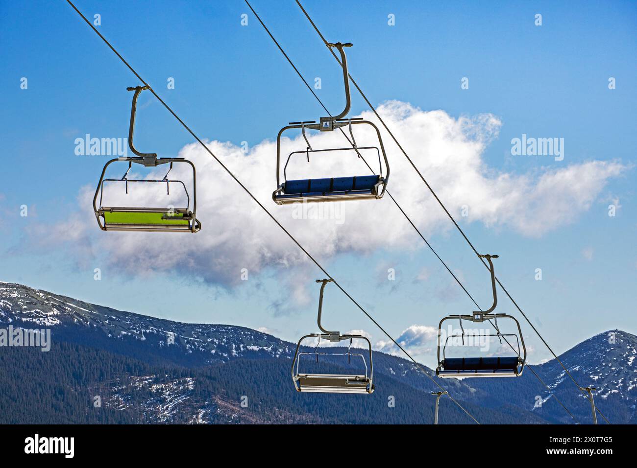 ski lifts against the background of a blue sky with clouds. Ski resort ...