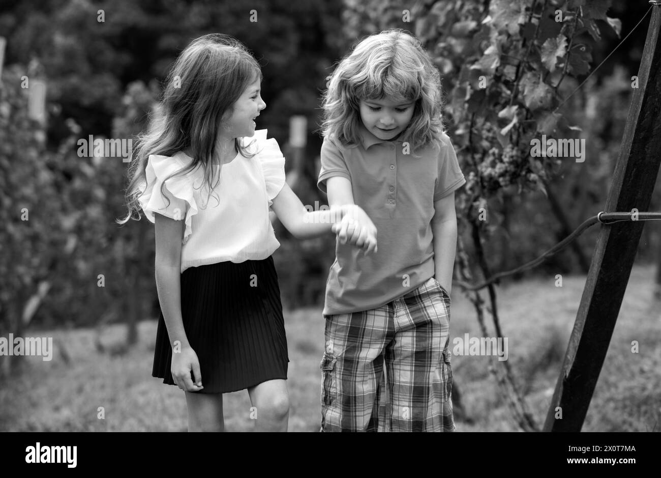 Two kids relaxing outdoors at summer park. Brother and sister happy ...
